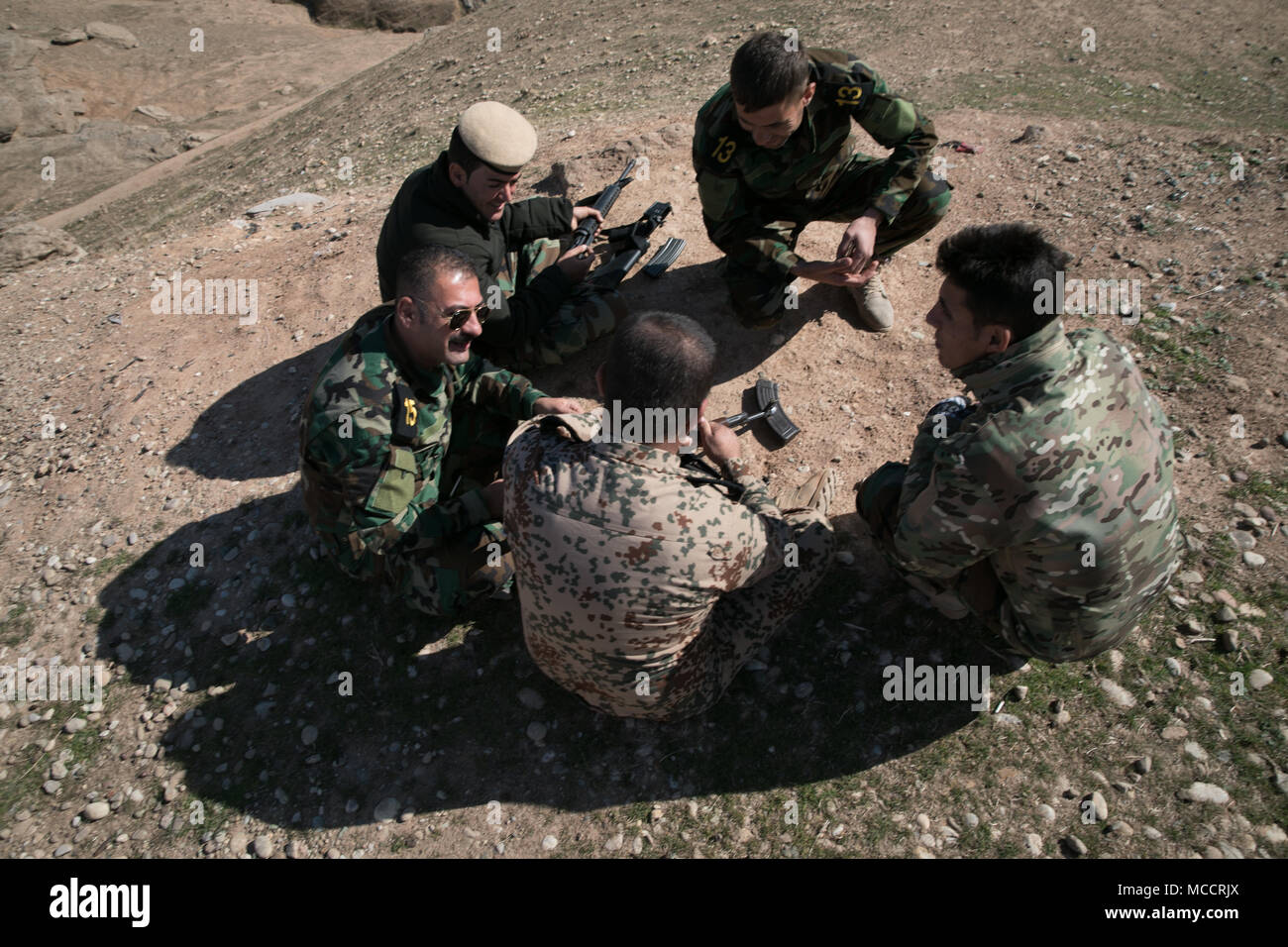 Security force members disassemble their weapons while learning basic ...