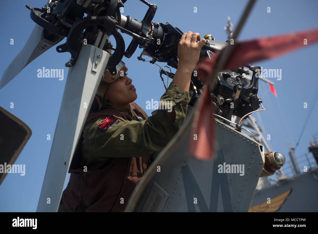 U.S. Marine Sgt. Brandi Morton, is inspecting the tail rotor of the AH ...