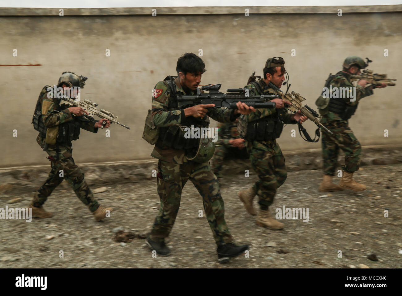 Commandos assigned to 1st Special Operations Kandak clear a training ...