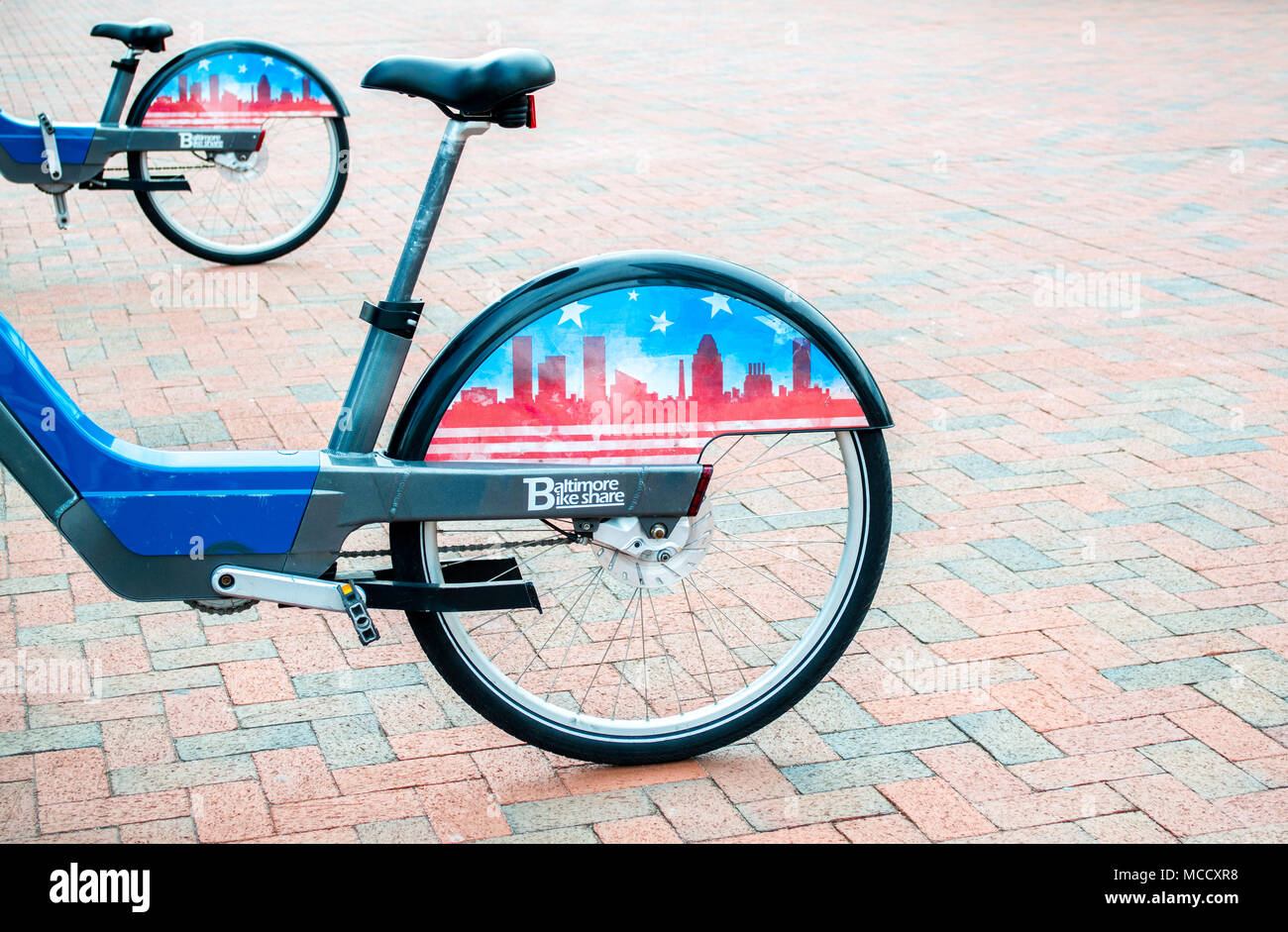 2 bicycle rear wheels from the Baltimore Bike Share program on a brick ...