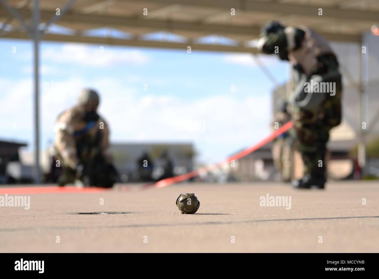 U.S. Airmen set up a cordon for a simulated unexploded ordnance during ...