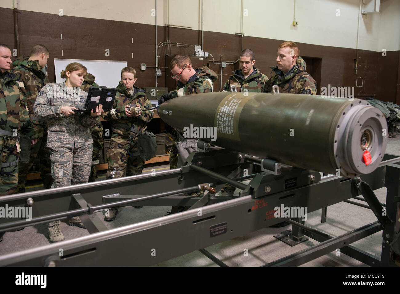Air Force Staff Sgt. Kristin Lookabaugh, third left, a munitions crew ...