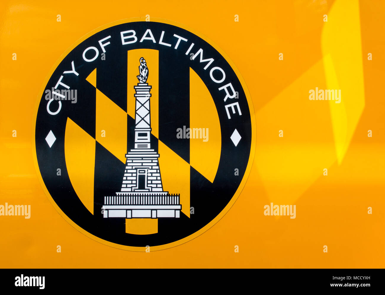 black and white graphic logo for the City of Baltimore on a gold ...