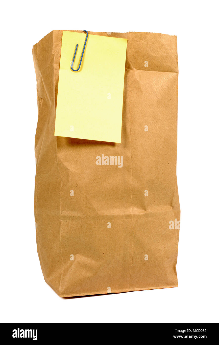 Brown paper lunch or groceries bag with yellow post it style sticky ...