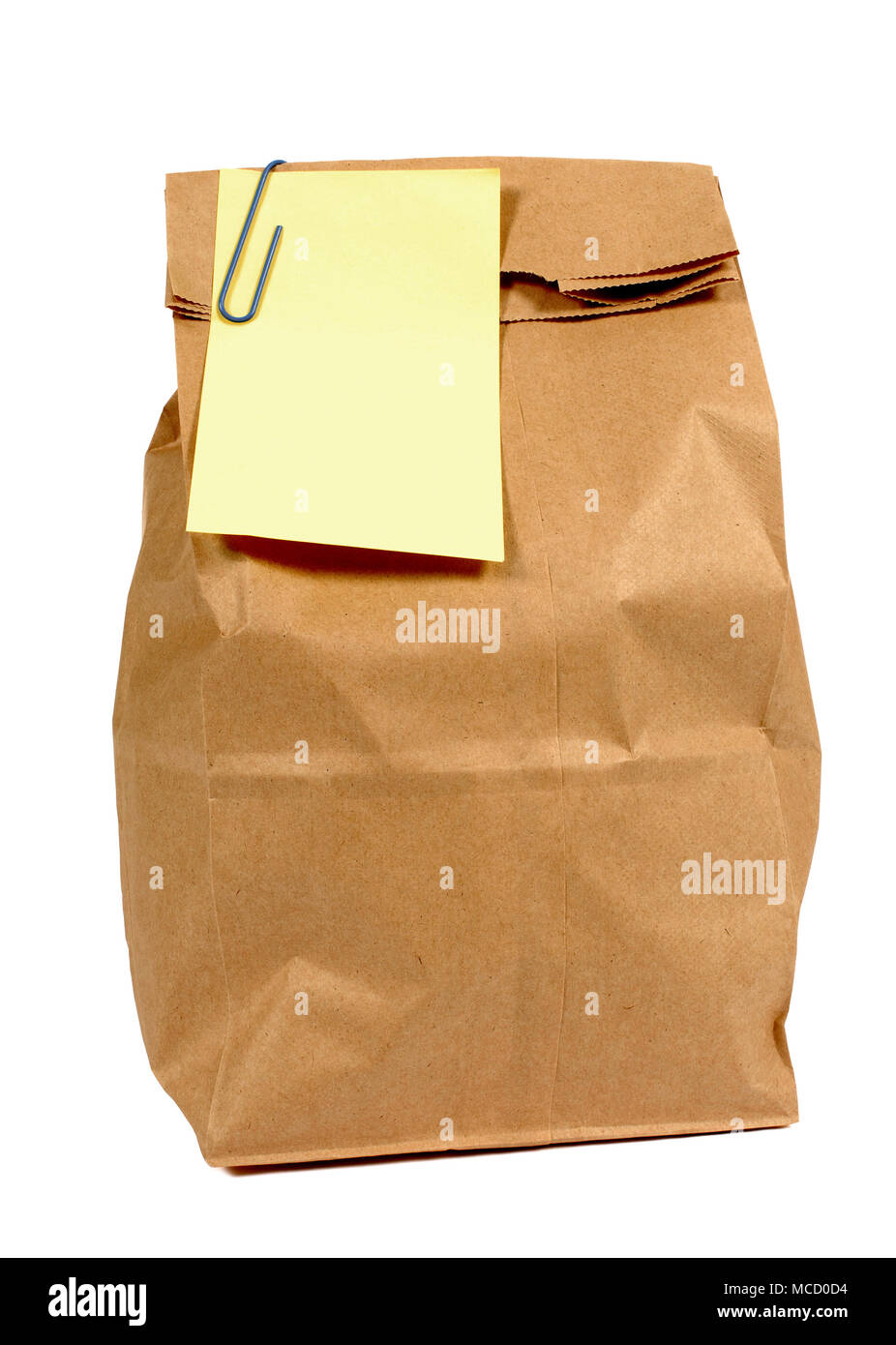 Brown paper lunch or groceries bag with yellow post it style sticky ...