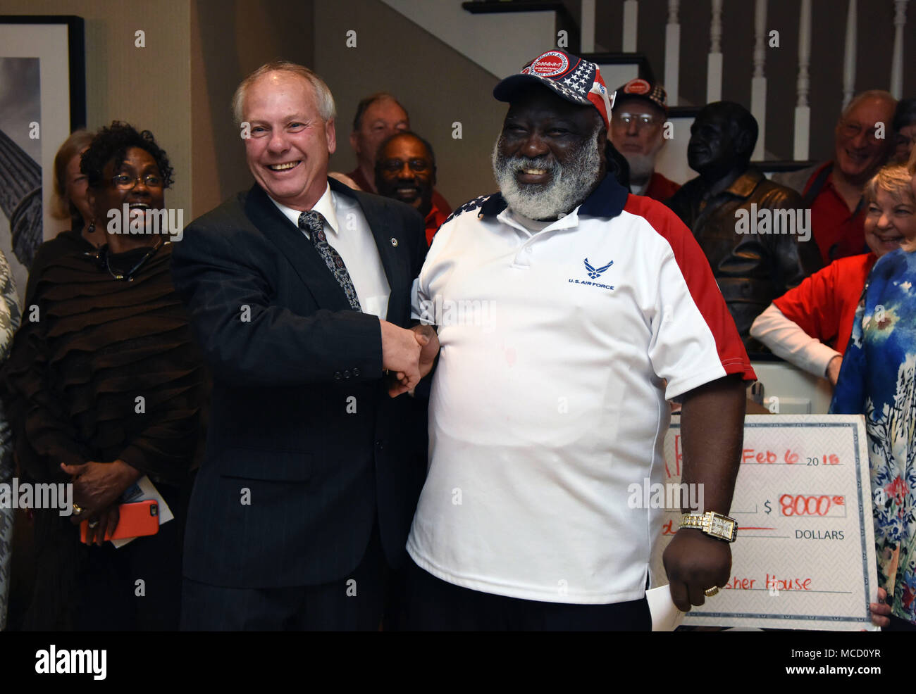 Larry Vetter, 81st Medical Group Fisher House director, accepts a check ...