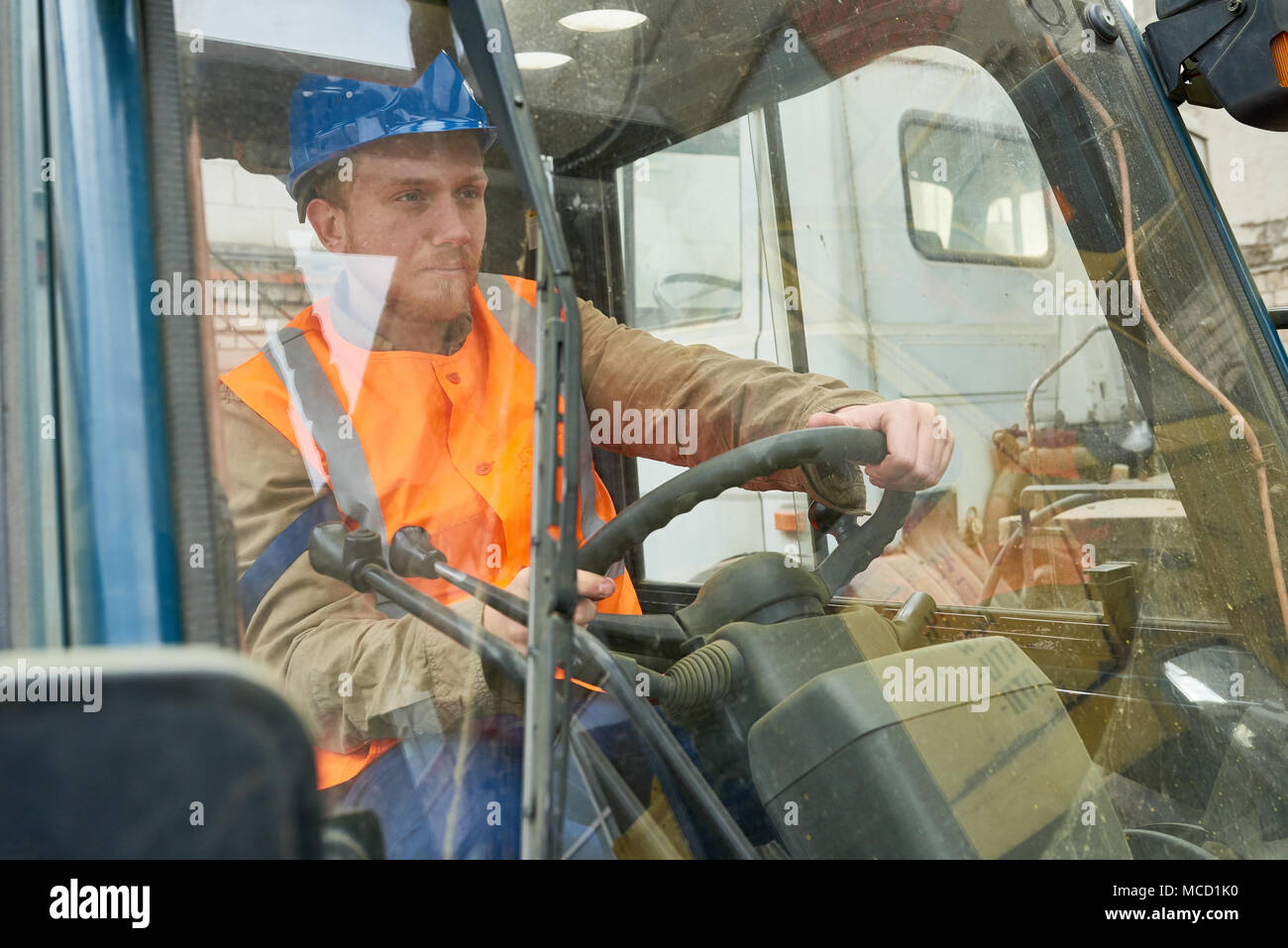Worker helmet driving forklift hi-res stock photography and images - Alamy