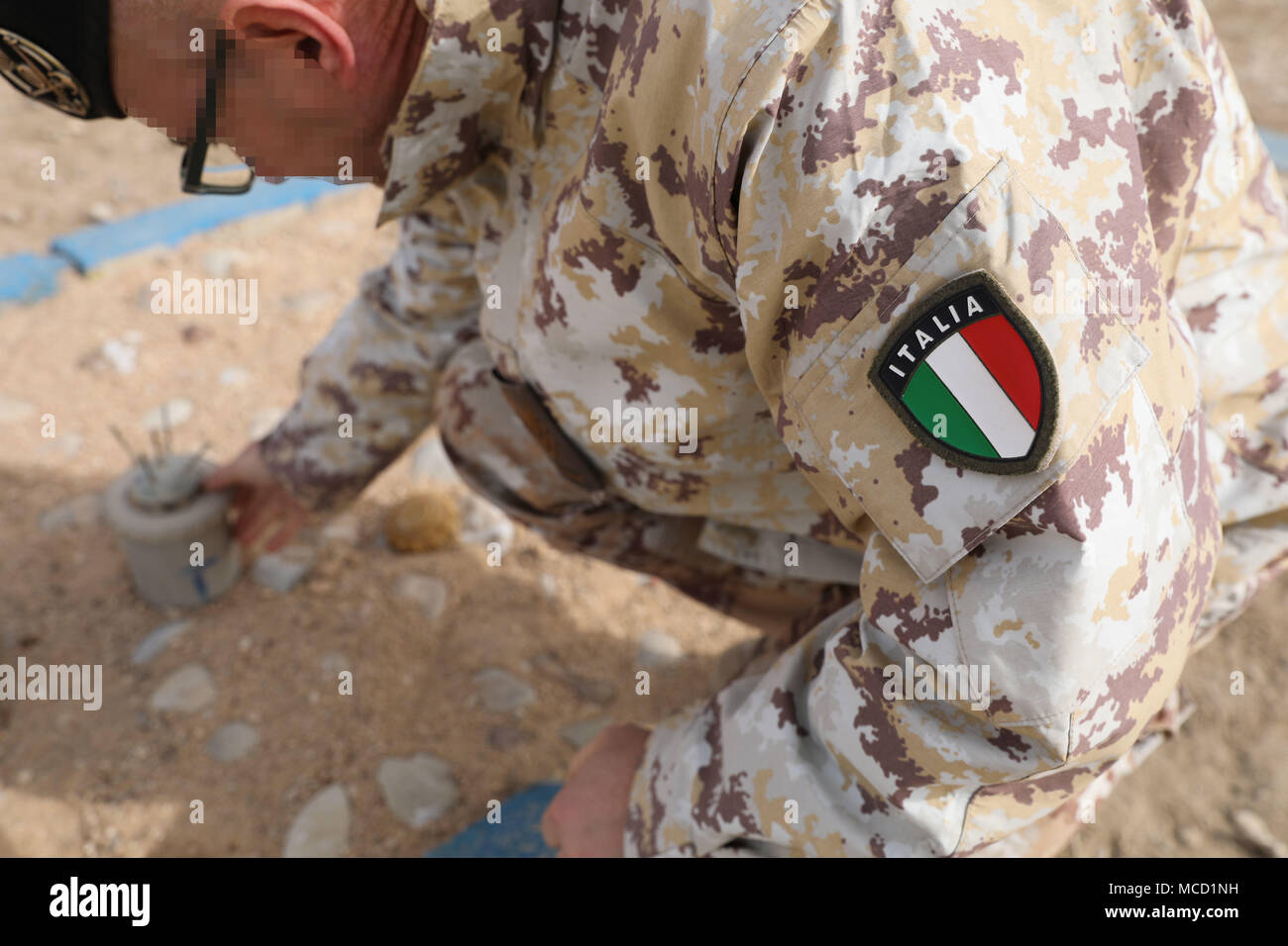 An Italian mentor checks an inert mine as part of a training area for ...