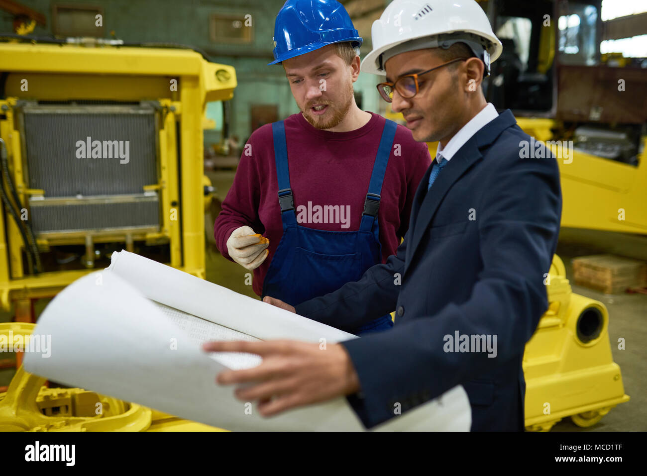 Studying Blueprint with Subordinate Stock Photo - Alamy