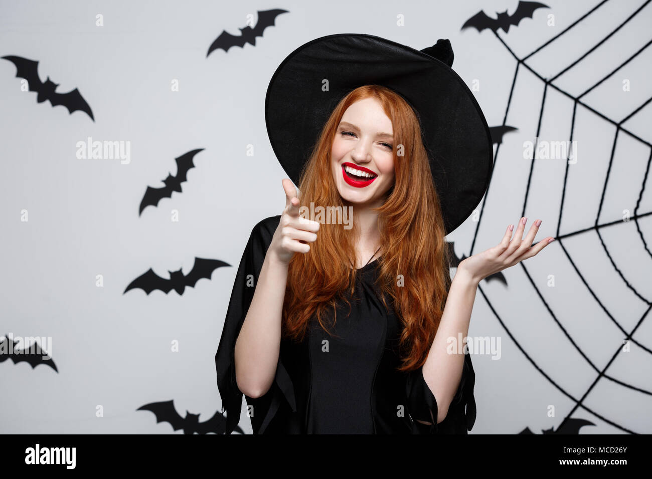 Halloween witch concept - Happy Halloween Witch pointing finger on side ...