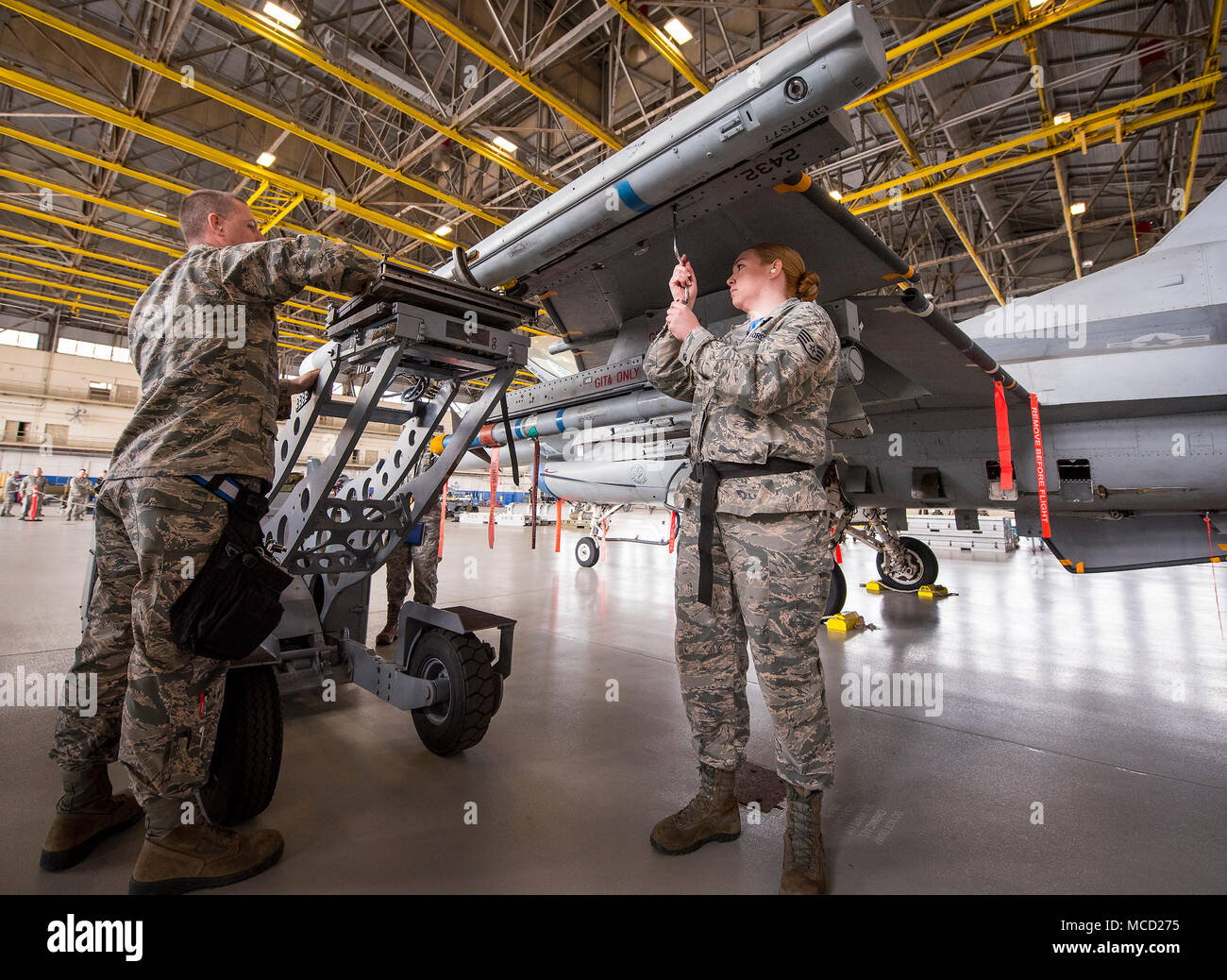 The 96th Aircraft Maintenance Squadron Blue Crew loads an AIM-120 onto ...