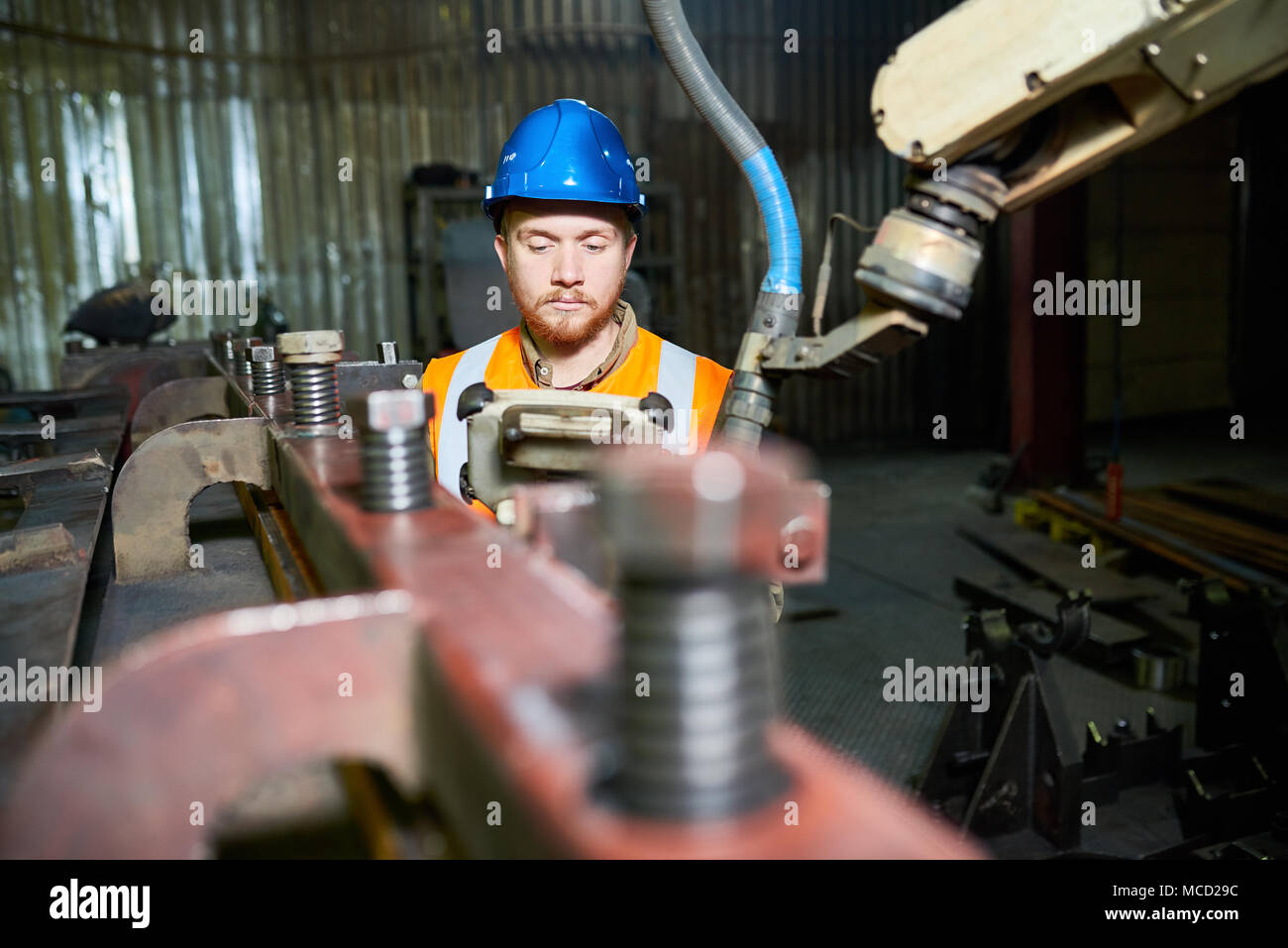 Machine Operator Wrapped up in Work Stock Photo - Alamy