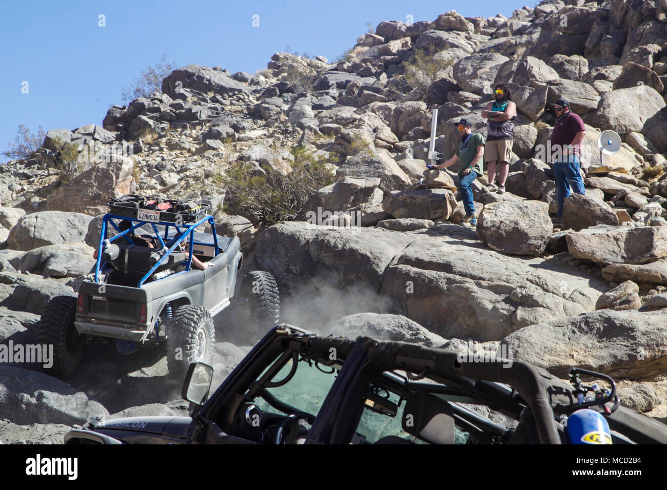 Riders and attendees test their vehicles on a trail during King of the ...