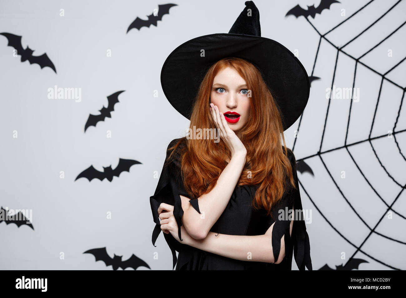 Halloween Concept - Beautiful caucasian witch shocking with something ...