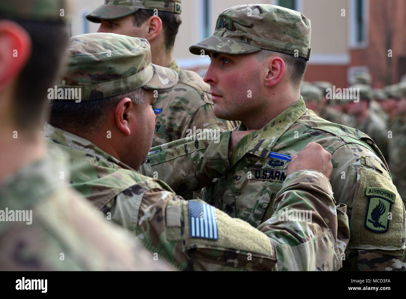 A U.S. Army Paratrooper assigned to the 173rd Airborne Brigade pins the ...