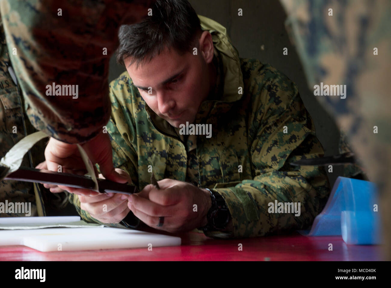 A Marine prepares an exterior strip charge during an urban breaching ...