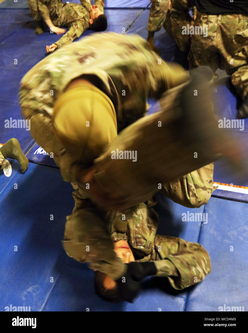Two Soldiers practice combatives techniques during a training session ...