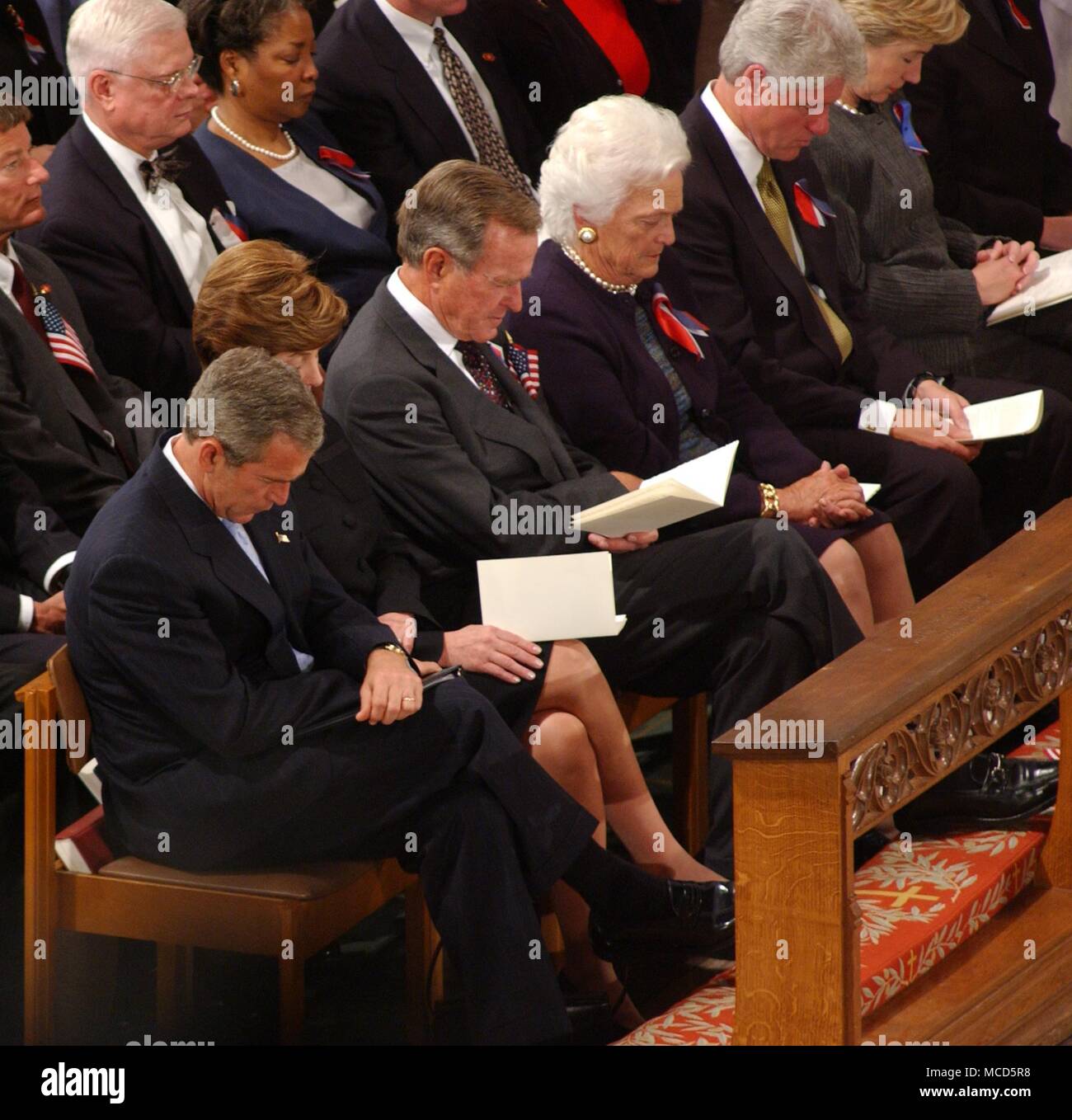 United States President George W. Bush bows his head in prayer during ...