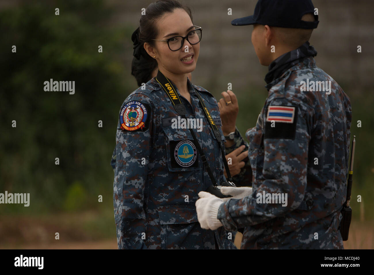 A member of the Royal Thai Air Force speaks to another Airmen working ...