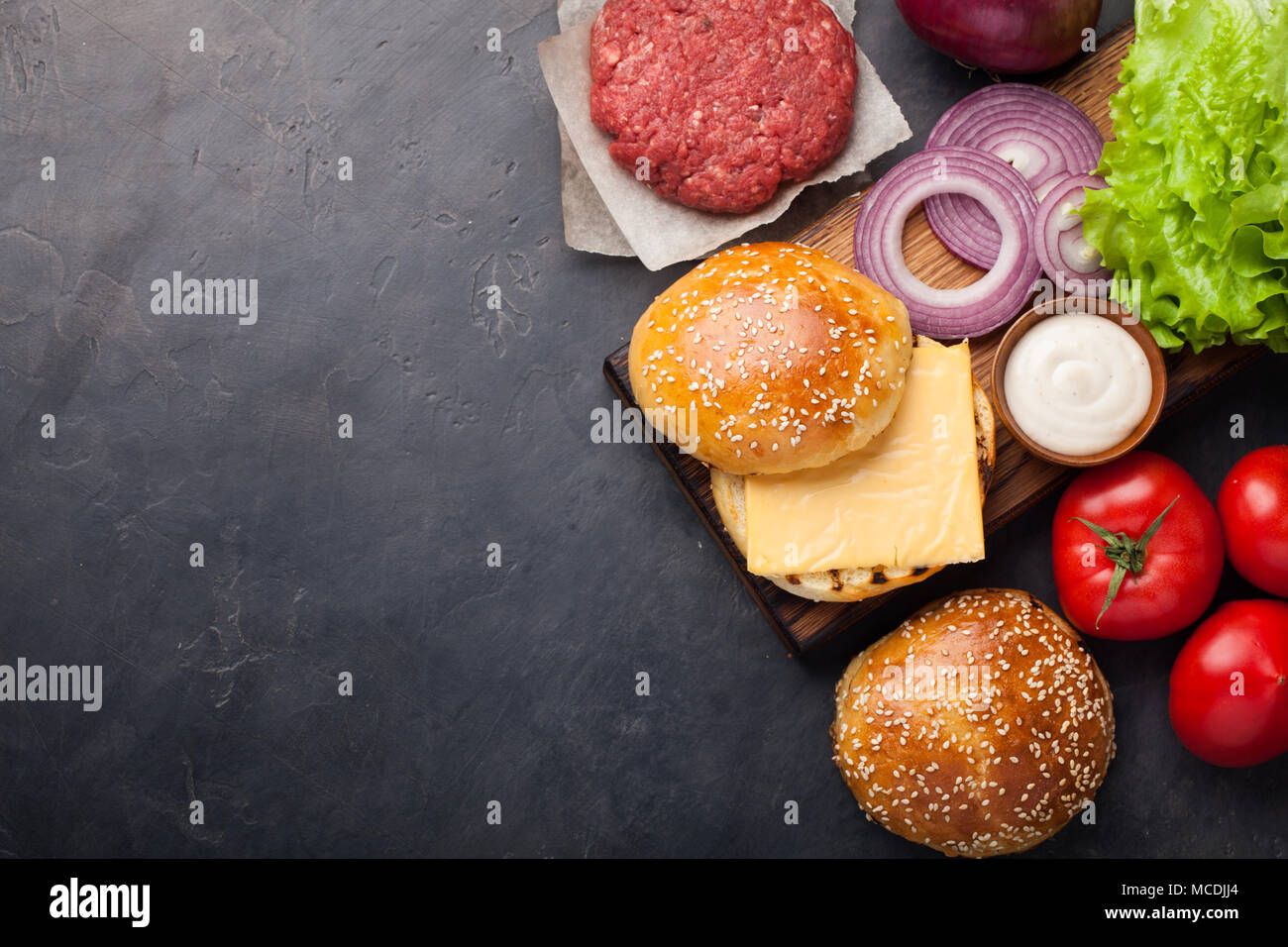 Hamburger Building Kit. Fresh ingredients for Burger on dark stone ...