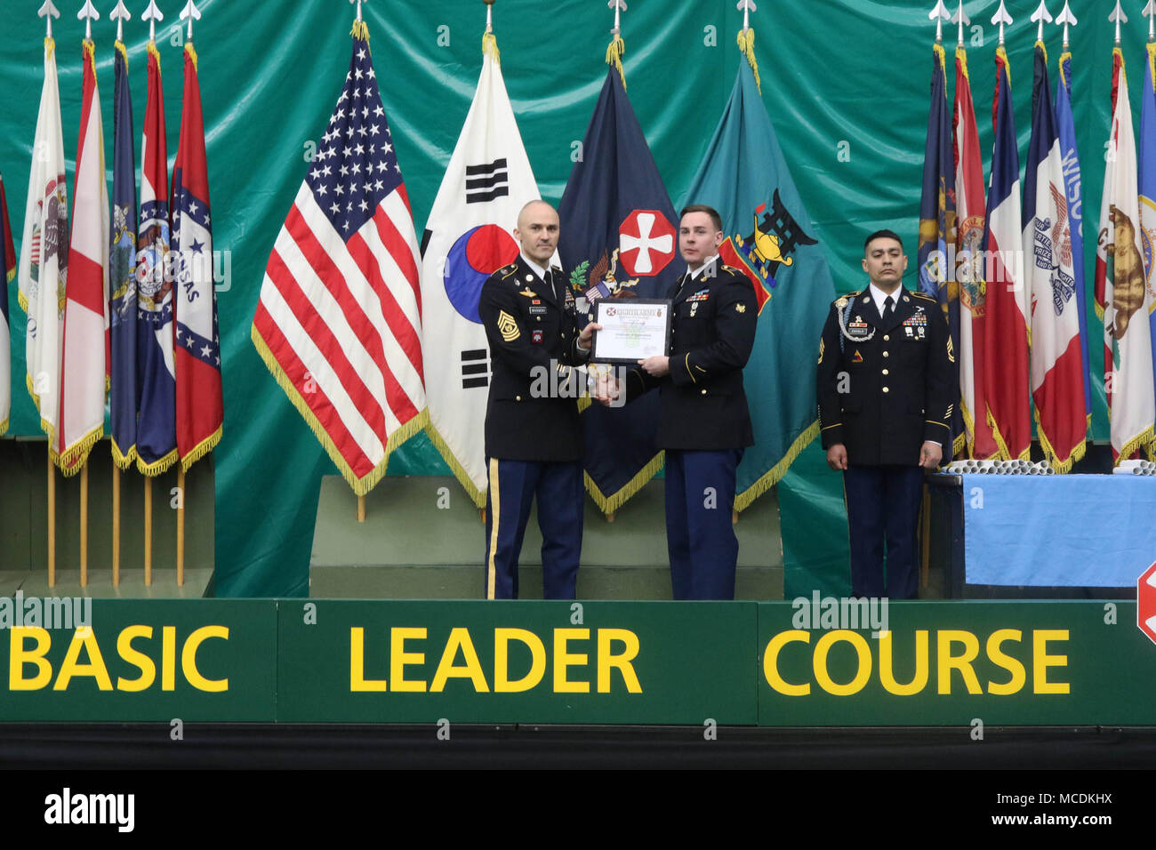 Command Sgt. Maj. James Musnicki presents Spc. Christopher McKinney the ...