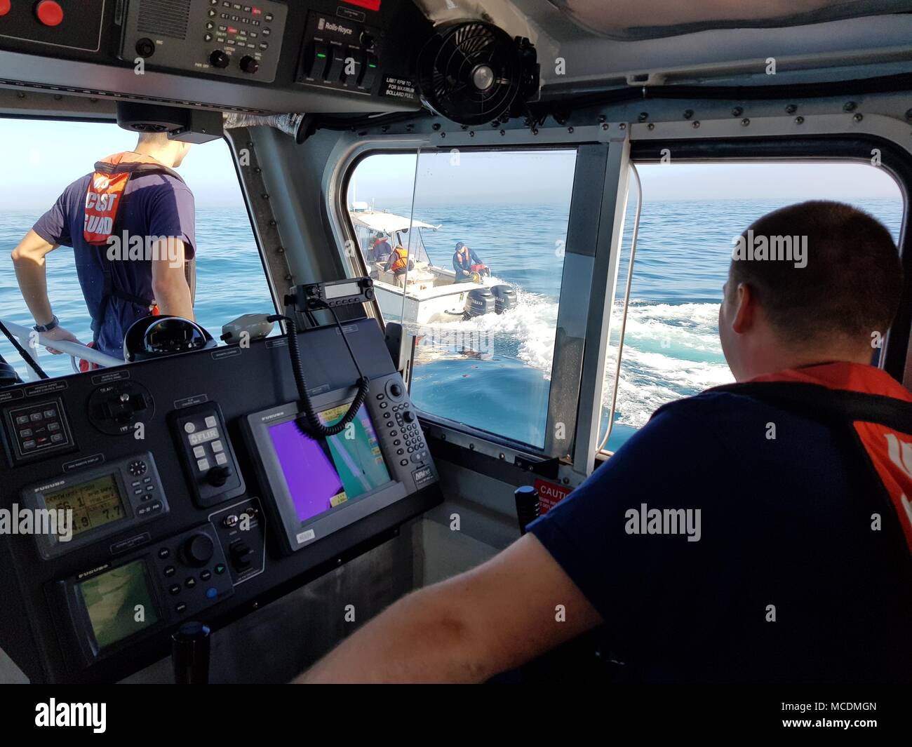 Petty Officer 2nd Class Ian Callahan navigates a Coast Guard 45-foot ...