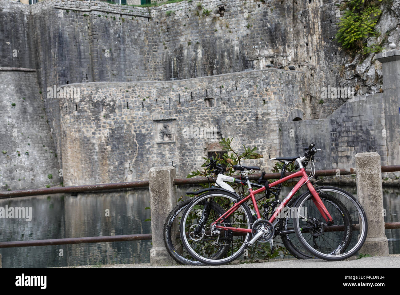 Two Bicycles by Lagoon and Old Fort in Kotor Stock Photo - Alamy
