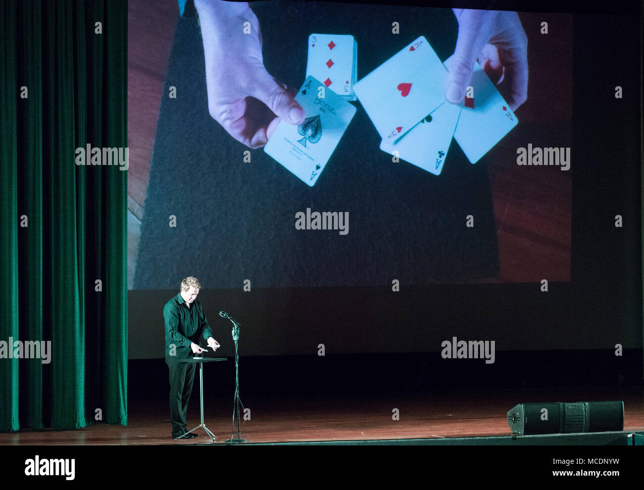 Magician and Illusionist Mike Super performs a close up card trick for ...