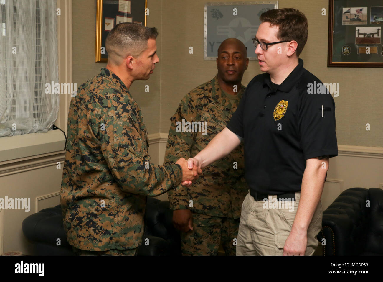 Police Officer Sean Sullivan is awarded a coin by Col. Timothy Miller ...