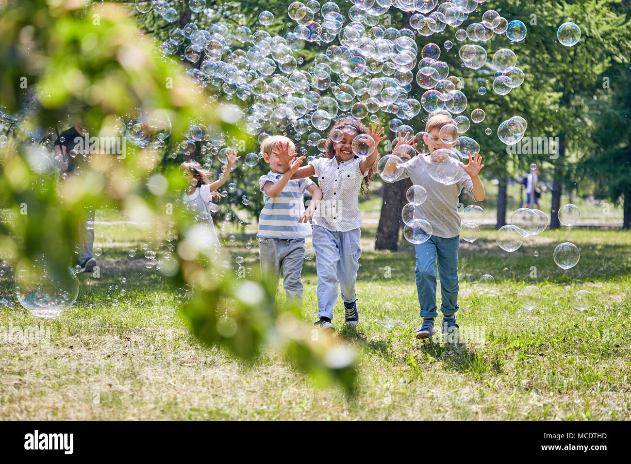 Cheerful Kids Playing with Soap Bubbles Stock Photo - Alamy