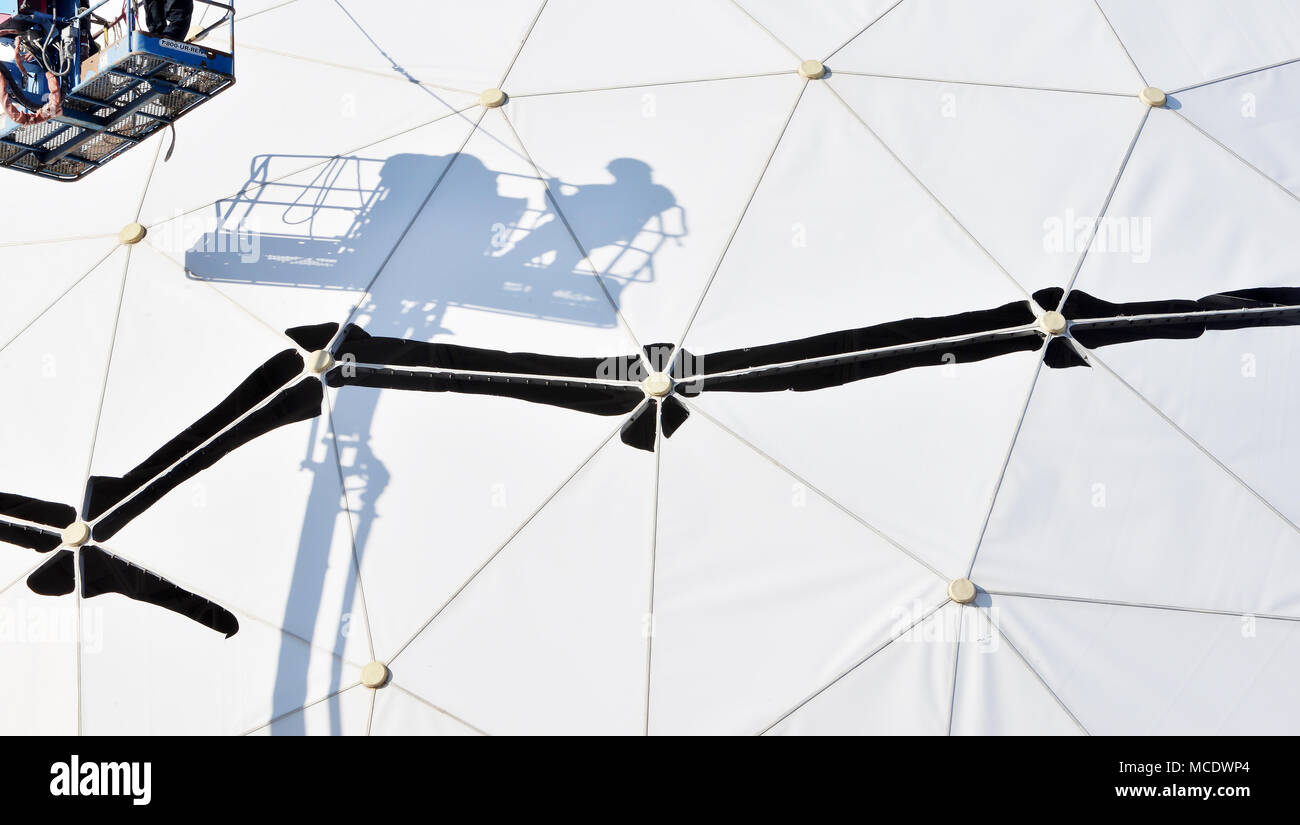 Employees from SAS construction disassemble the protective enclosure ...