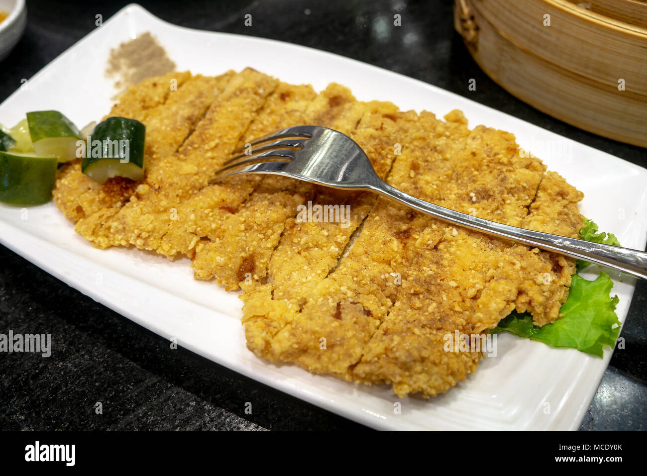 Taiwanese style fried pork chop with spoon Stock Photo - Alamy
