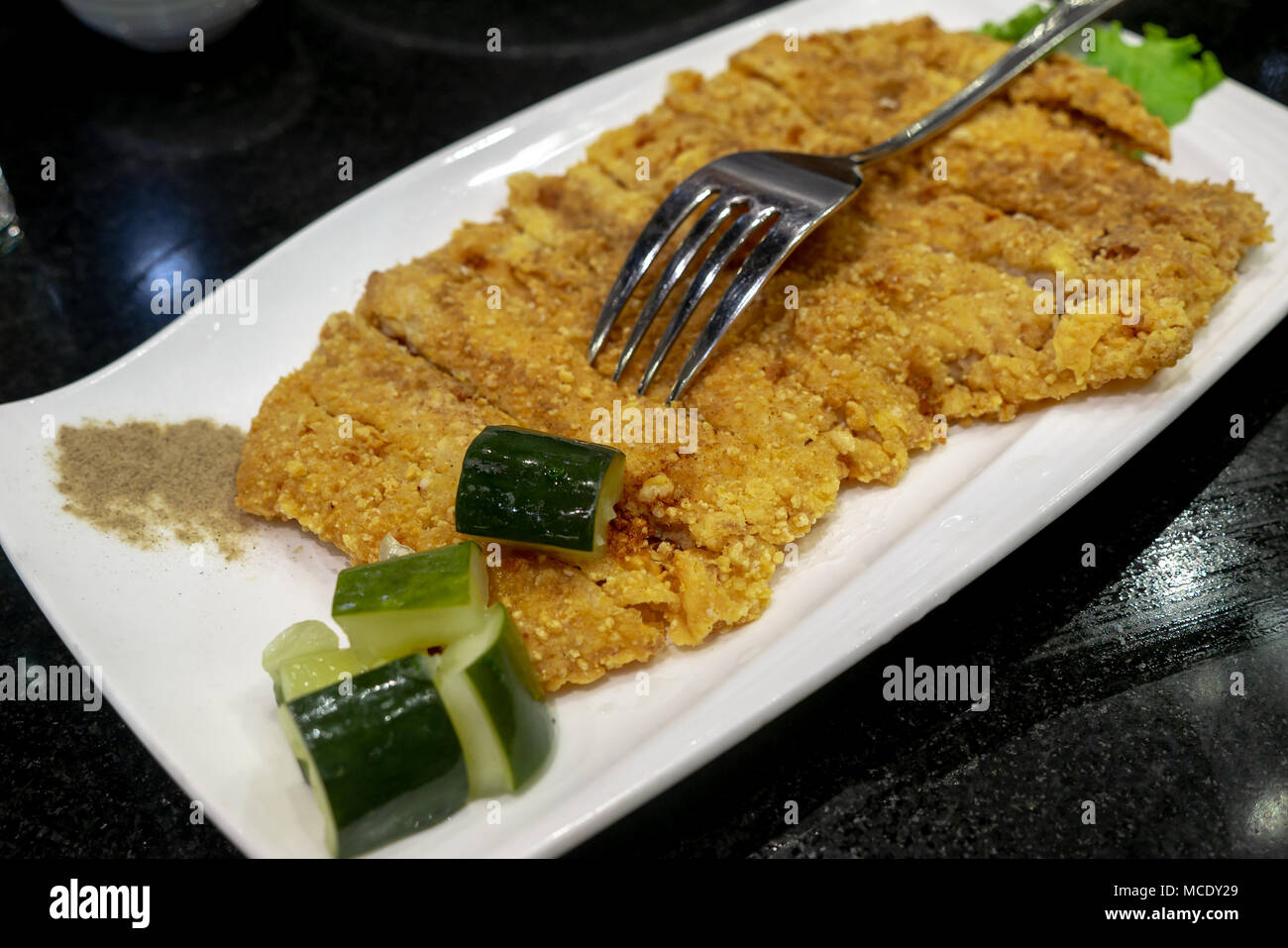 Taiwanese style fried pork chop with spoon Stock Photo - Alamy
