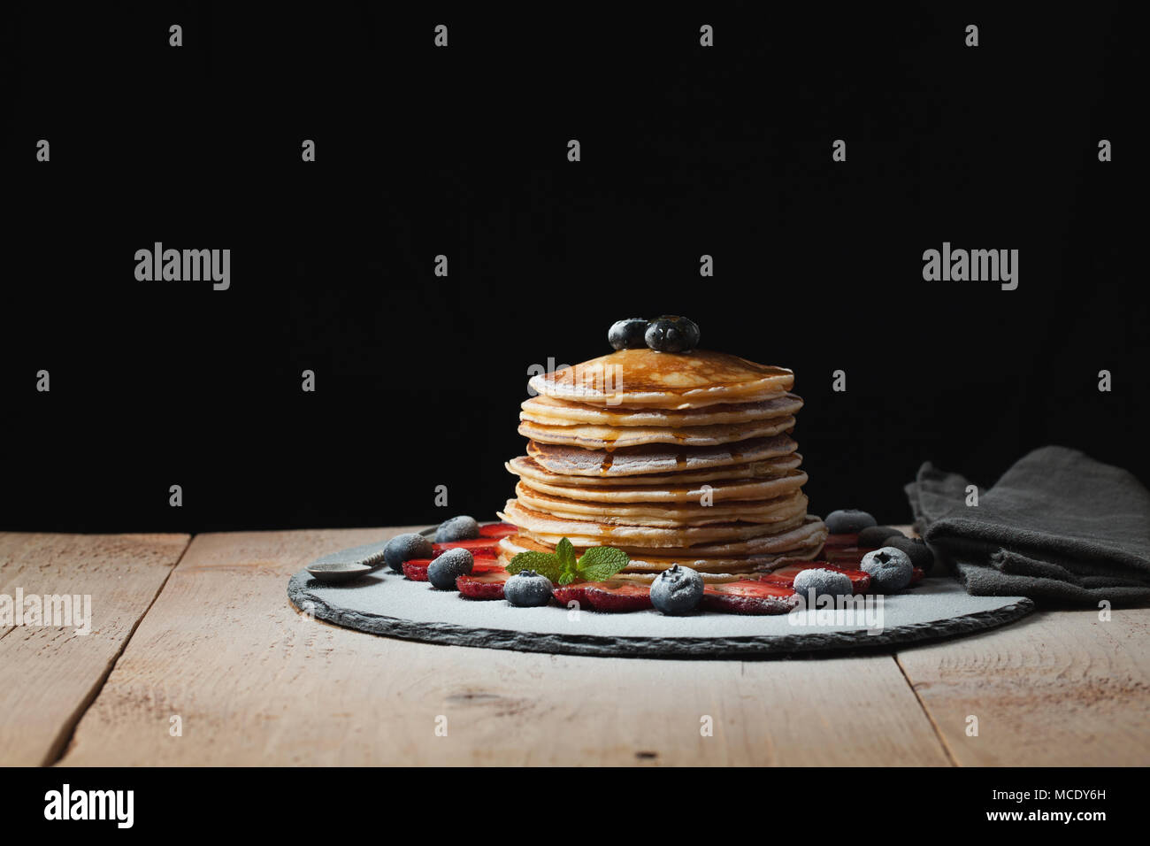 Front view of Stack of homemade plain pancakes with strawberries ...