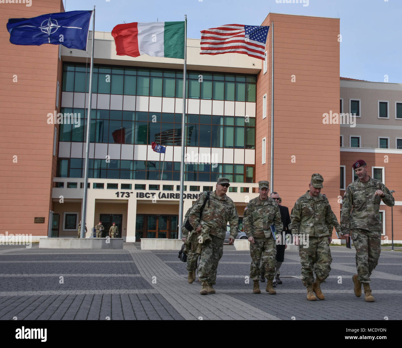 The NATO, Italian and American flag provide the backdrop for the ...