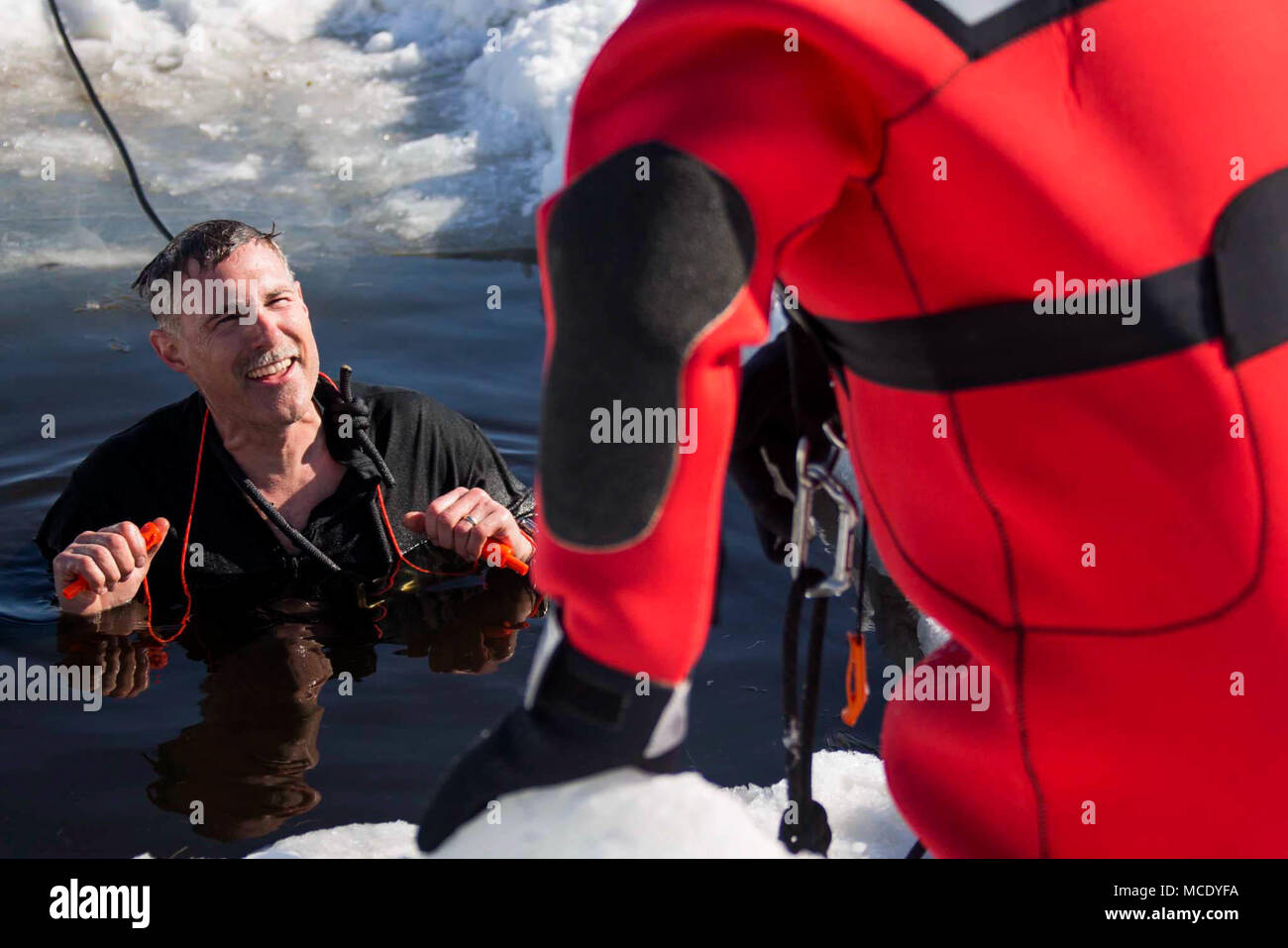 U.S. Marine Corps Lt. Col. Lawrence B. Green stands in freezing water ...