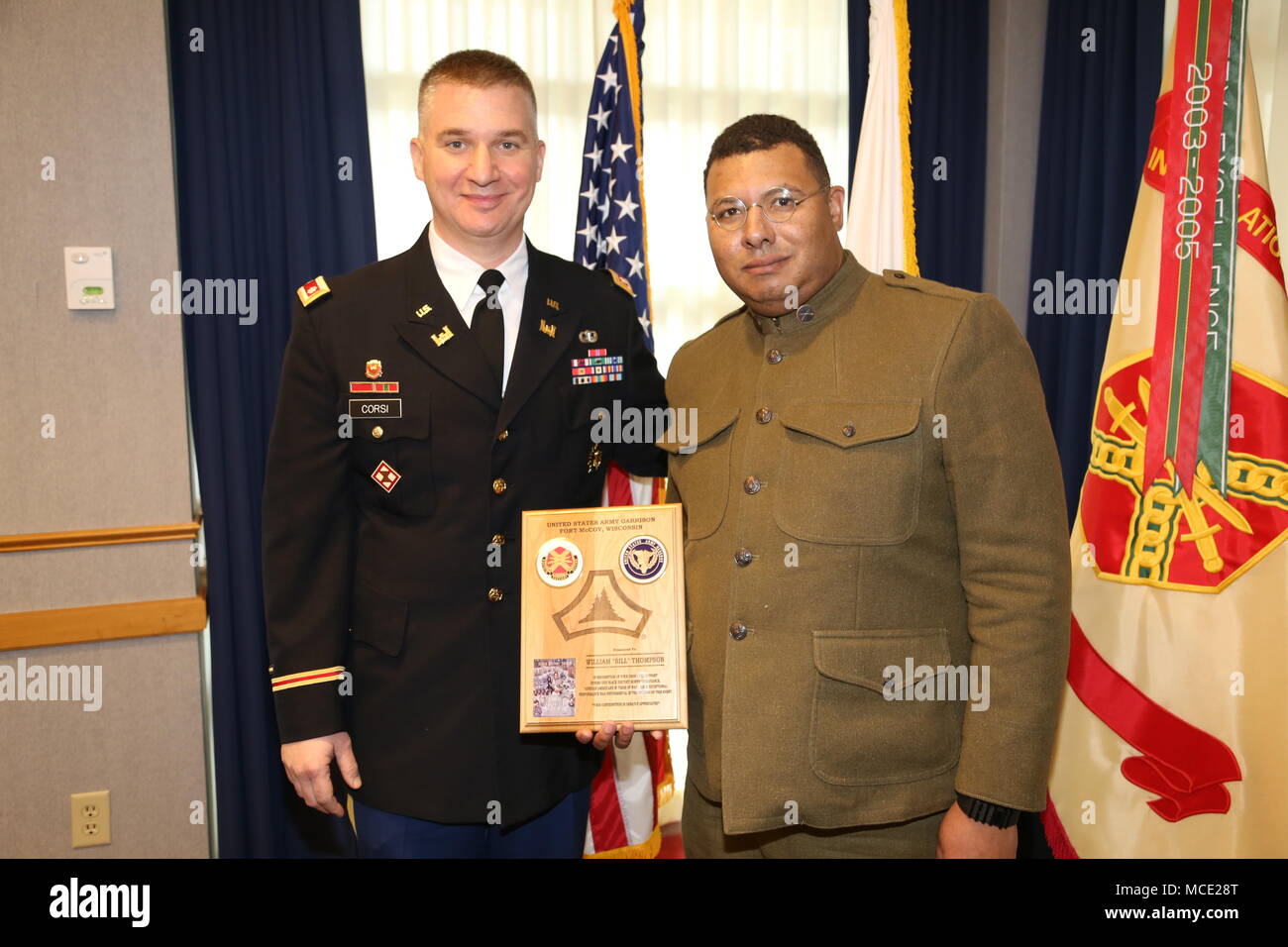 Garrison Deputy Commander Lt. Col. Jared T. Corsi presents a plaque of ...