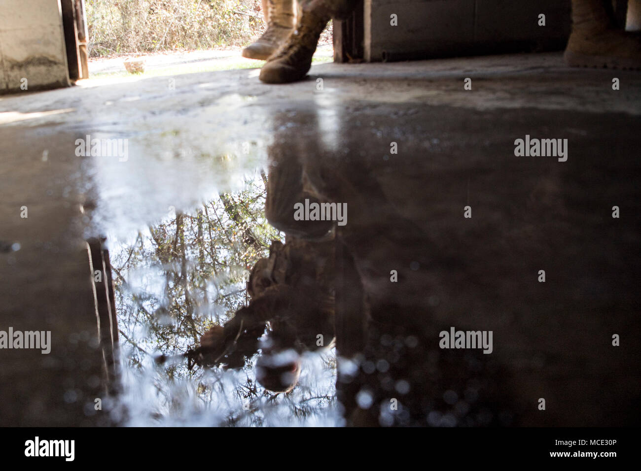 Airmen from the 824th Base Defense Squadron enter a building during ...