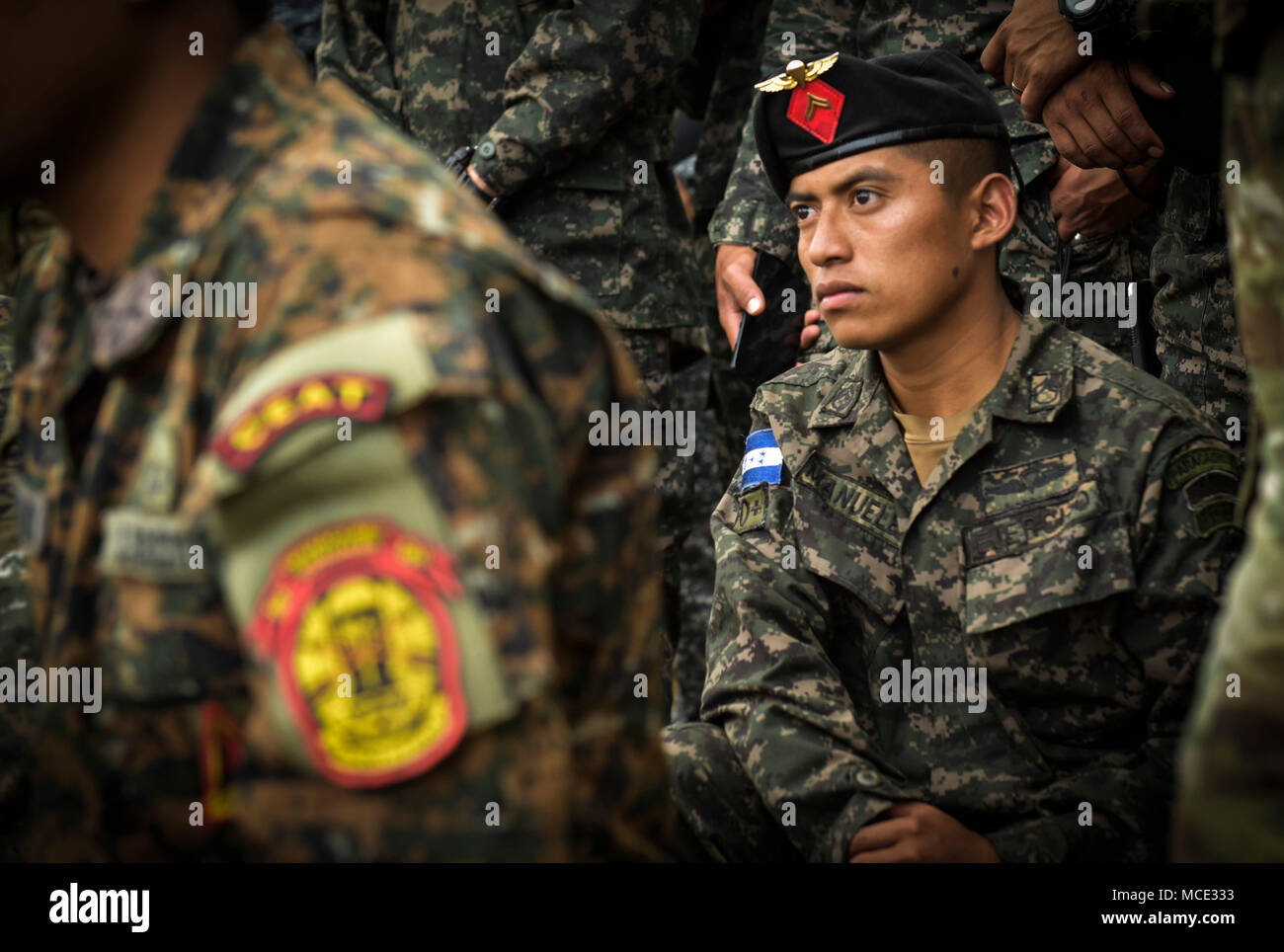 A Honduran soldier with the 2nd Airborne Infantry Battalion listens to ...