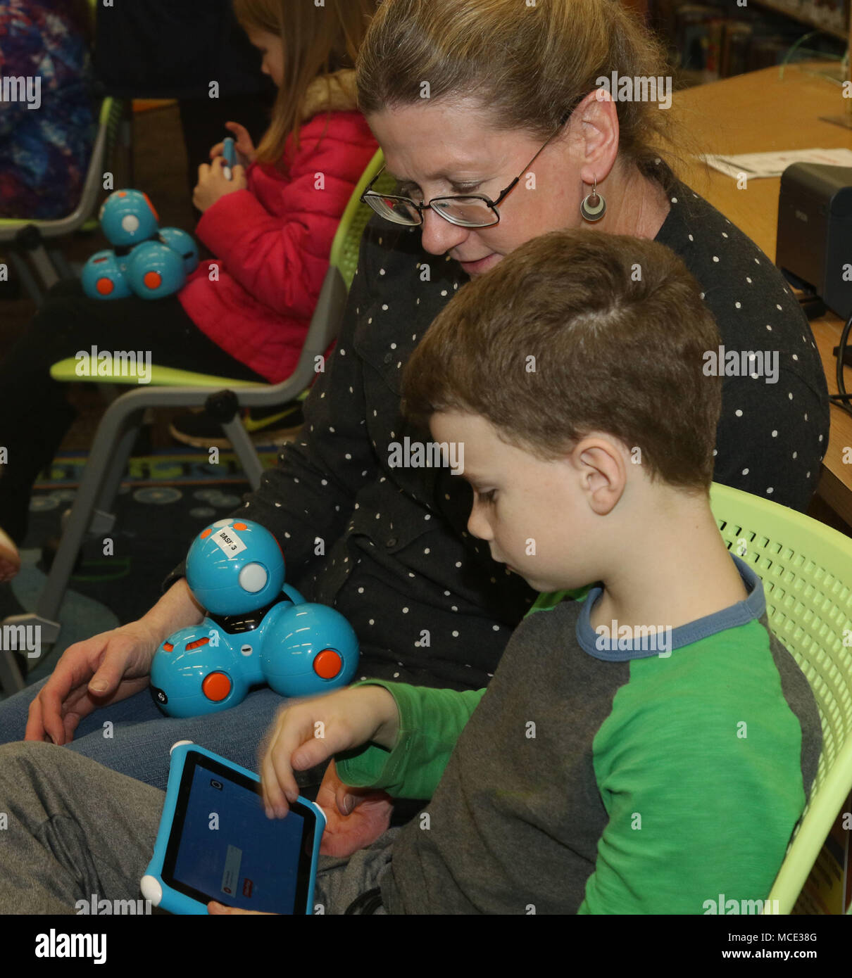 Librarian technician Erin Spencer and her grandson, Aiden, work ...