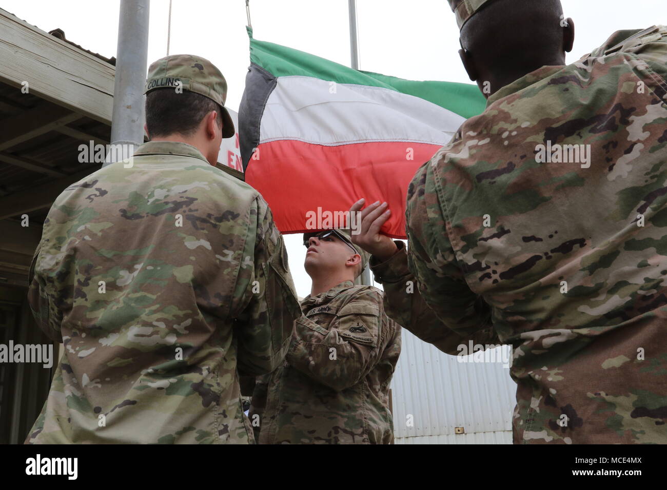 A flag detail from the 40th Brigade Engineer Battalion lowers an aging ...