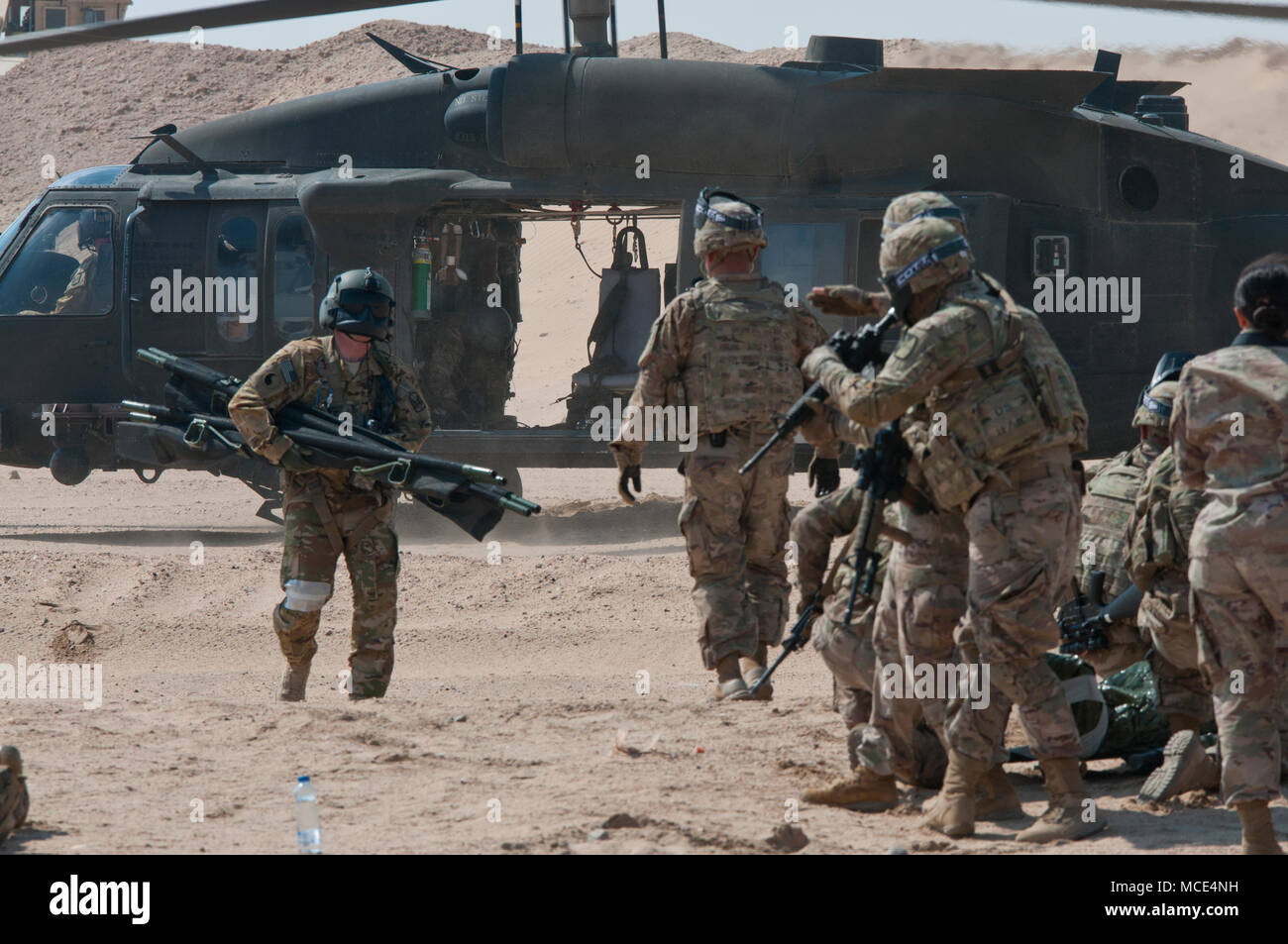 A flight medic approaches Soldiers from Delta Battery, 1st Battalion, 145th Field Artillery ...