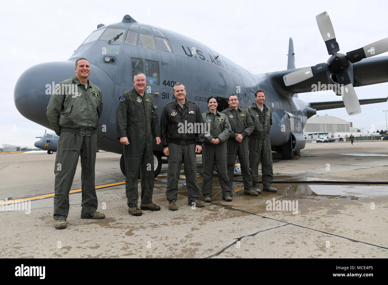 Crew members stand with Col Jeffrey Van Dootingh, Commander of the ...