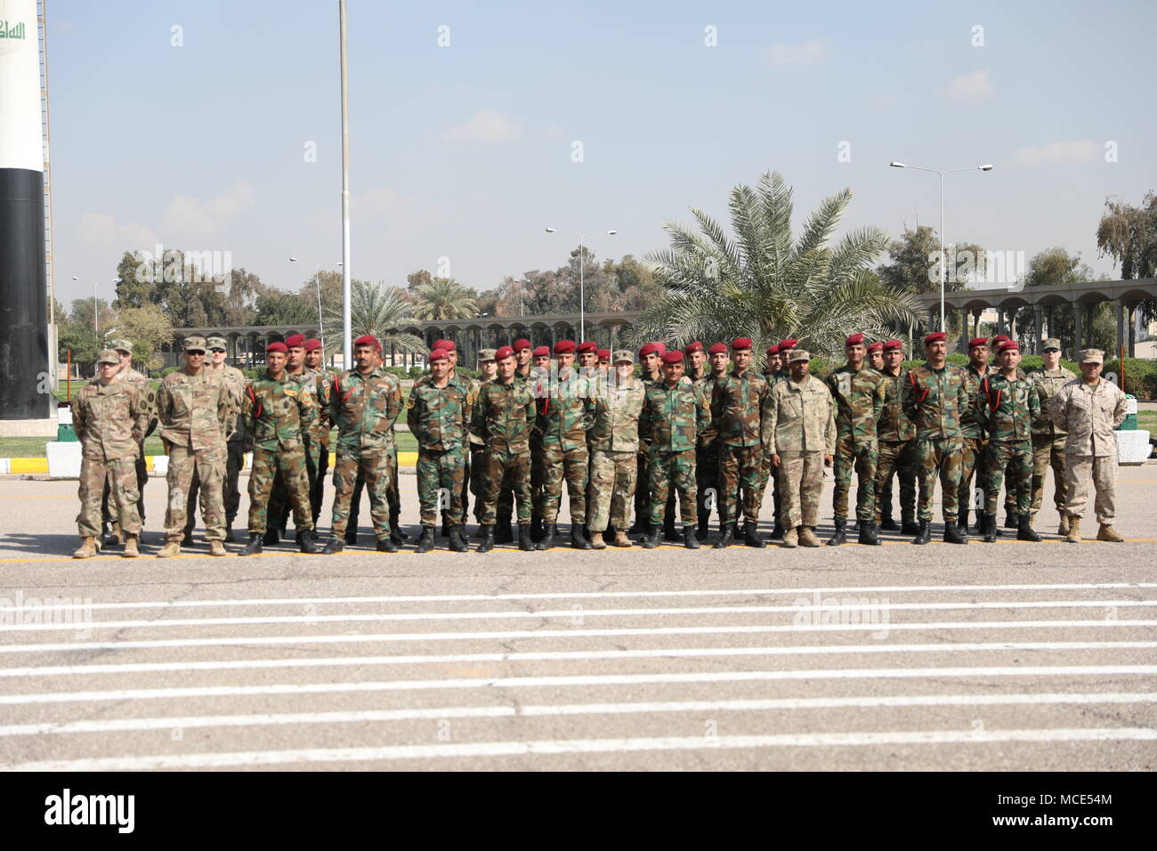 U.S. military non-commissioned officers stand with Iraqi soldiers while ...