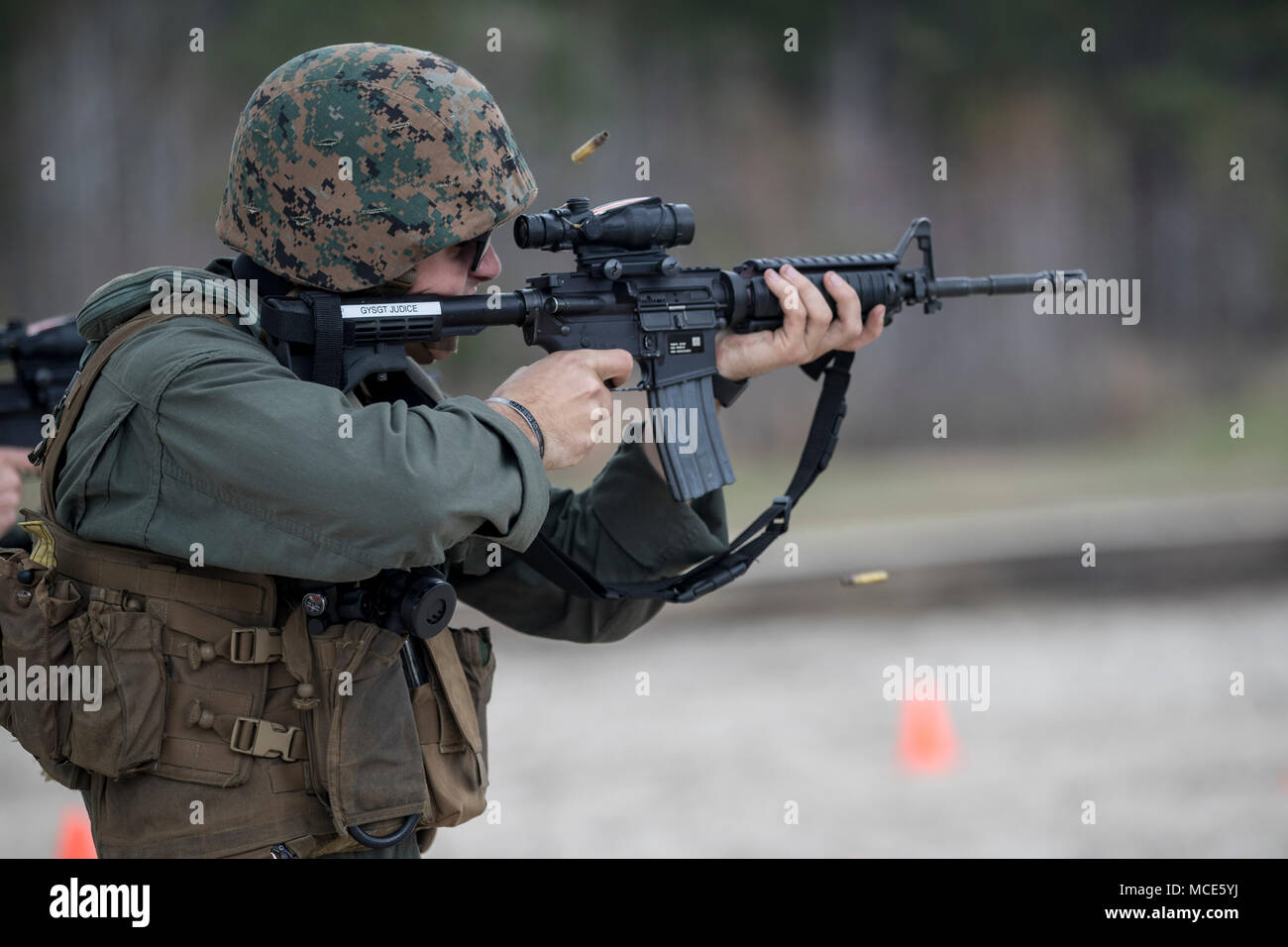 U.S. Marine Corps Lance Cpl. Daniel L. Fessenden fires an M4 carbine ...
