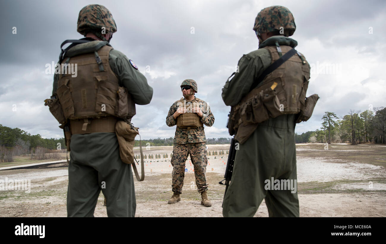 U.S. Marine Corps Gunnery Sgt. Nicky R. Molina, center, instructs ...