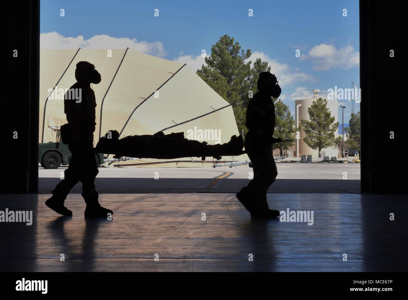 Airmen from the 49th Maintenance Group litter carry a simulated ...