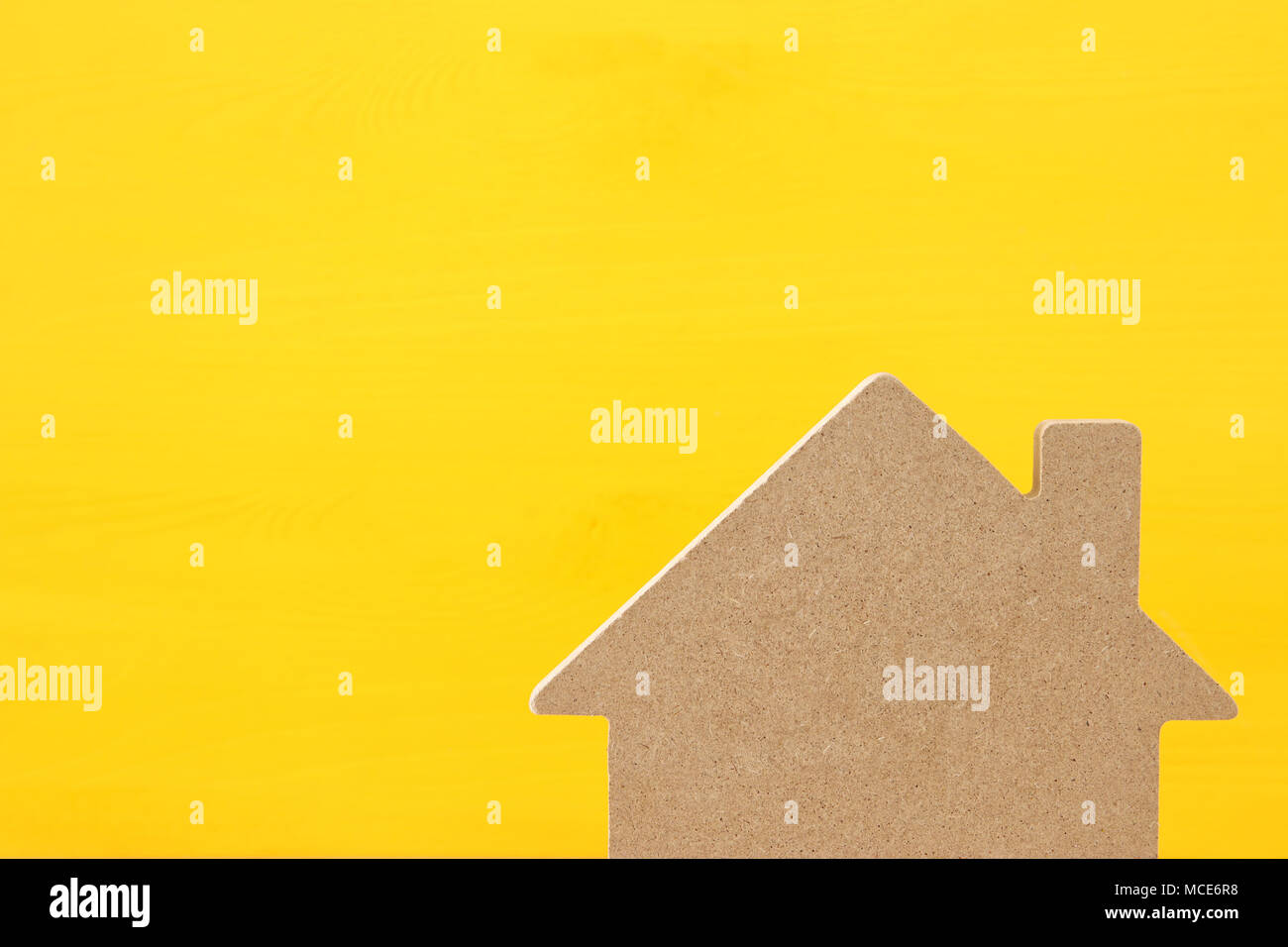 Image of wooden house model over yellow background. Real estate concept ...
