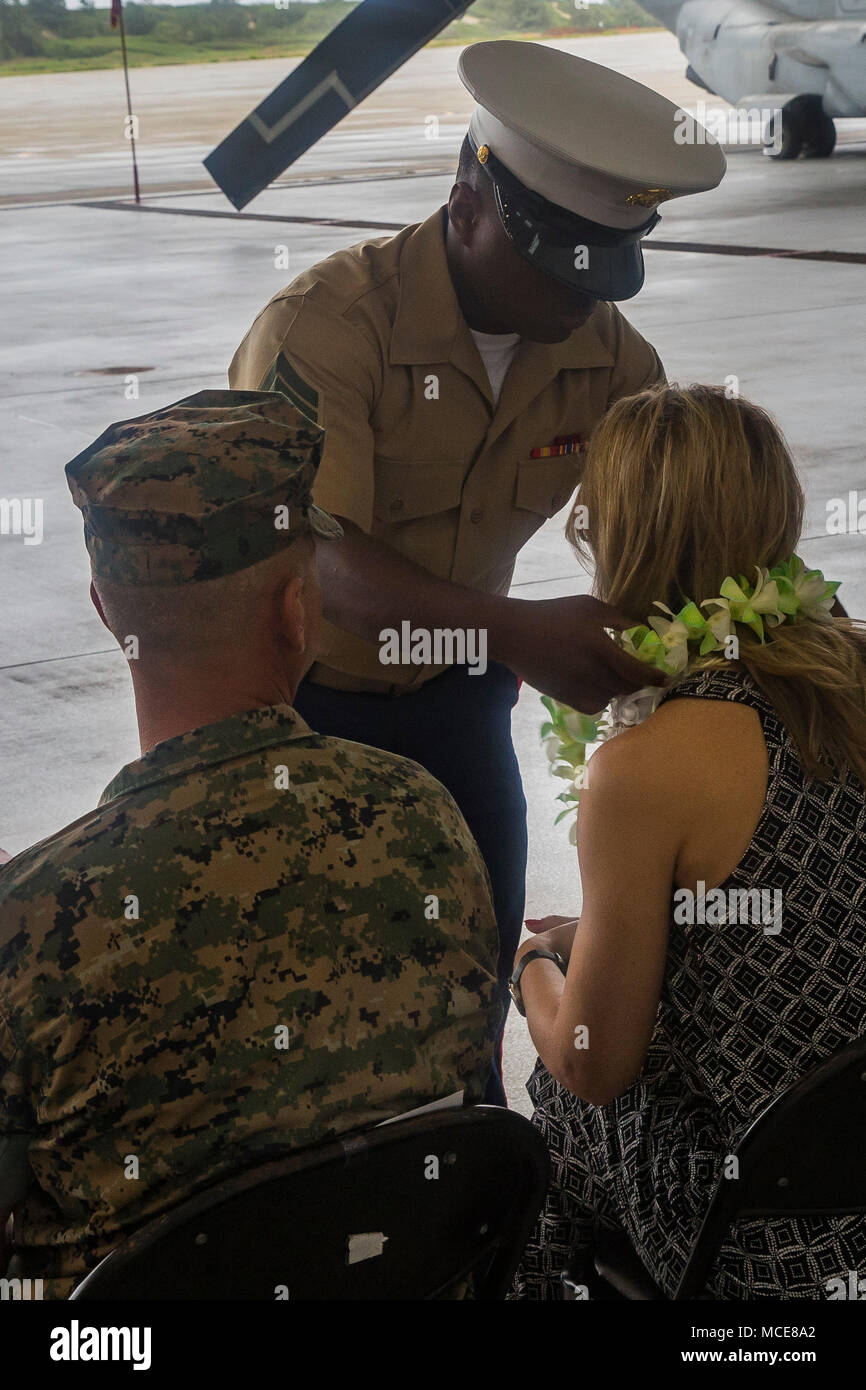 A U.S. Marine presents the wife of Sgt.Maj. Douglas Hester, off-going ...
