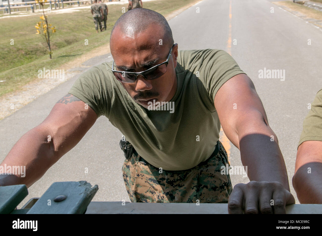 Sgt. Daniel Dugger exerts max effort during a Humvee push competition ...
